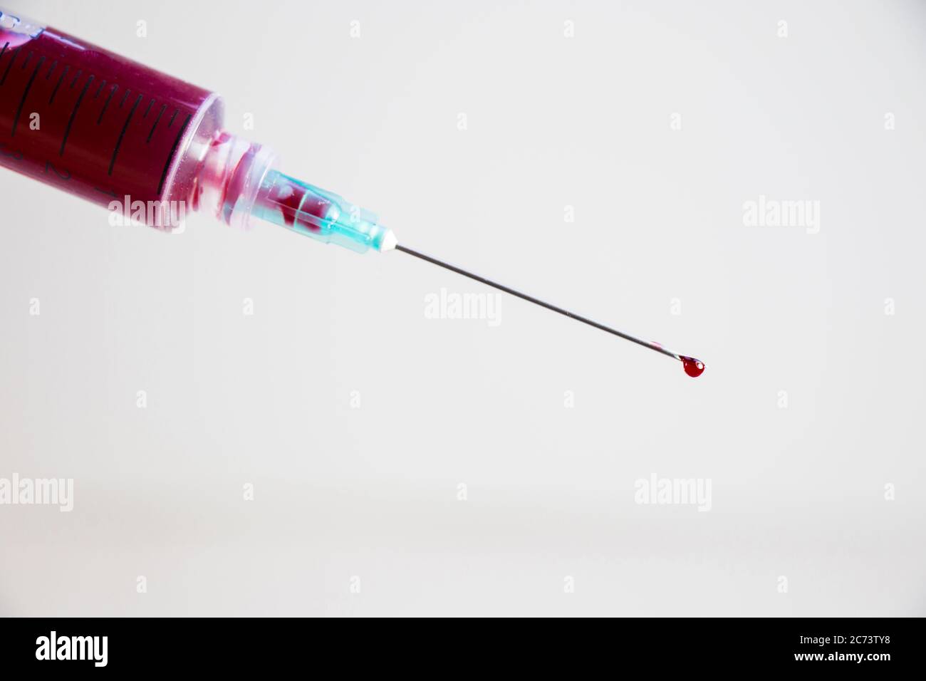 needle injection with blood on the white background. Laboratory test ...