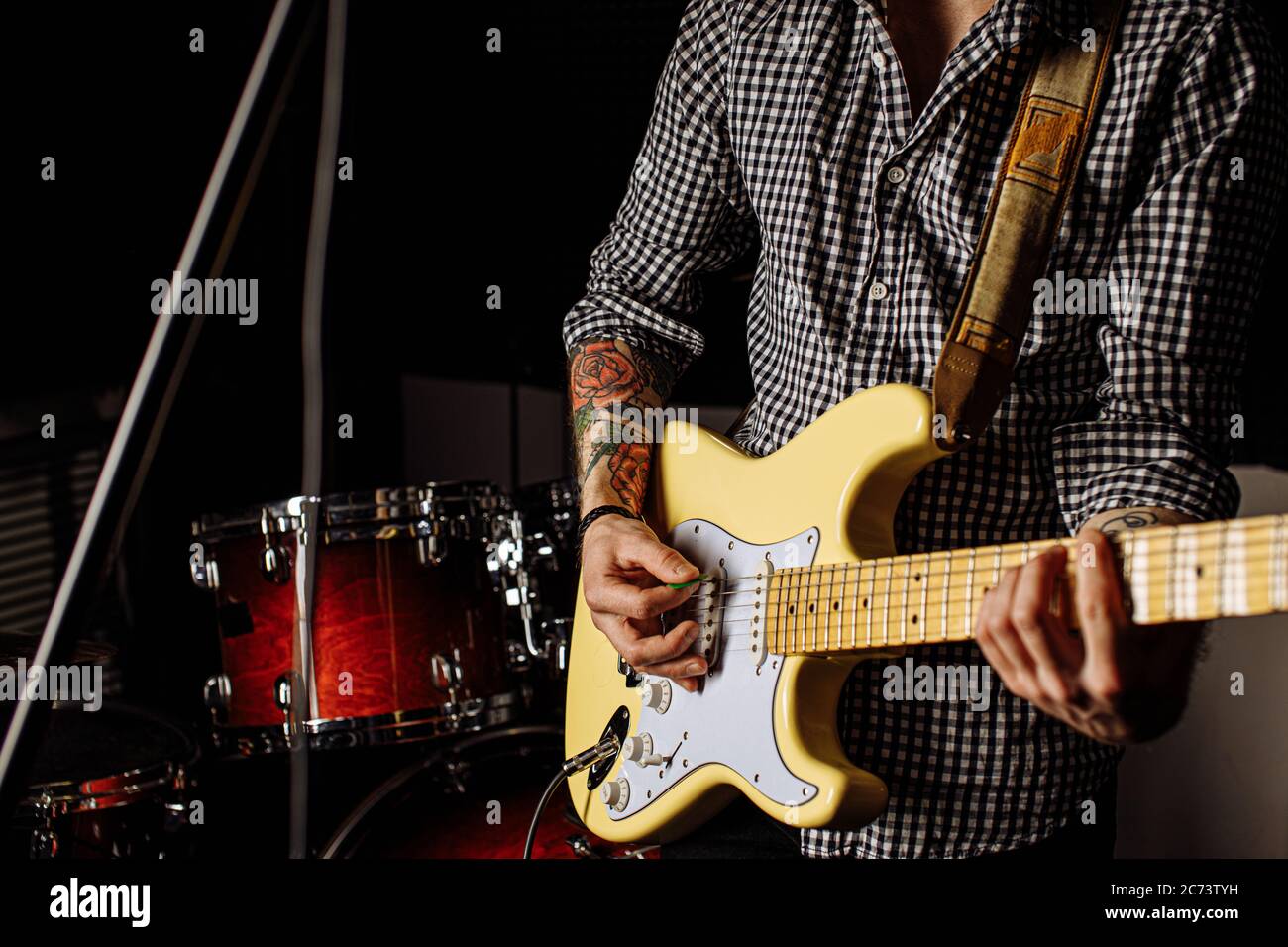 cropped caucasian man perform music with the use of electric guitar ...