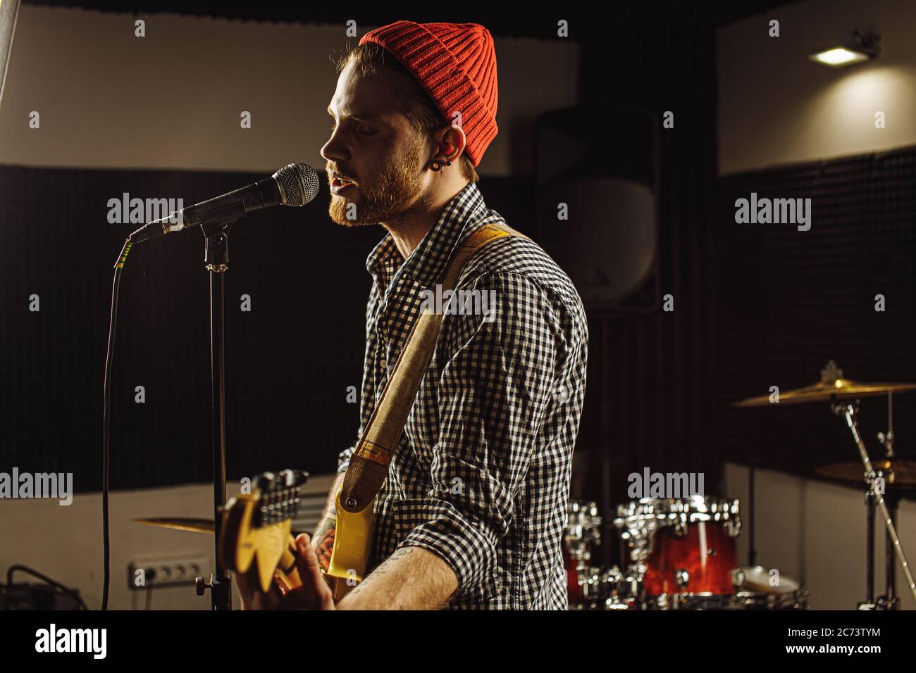 young caucasian gorgeous musician play electric guitar and sing on ...