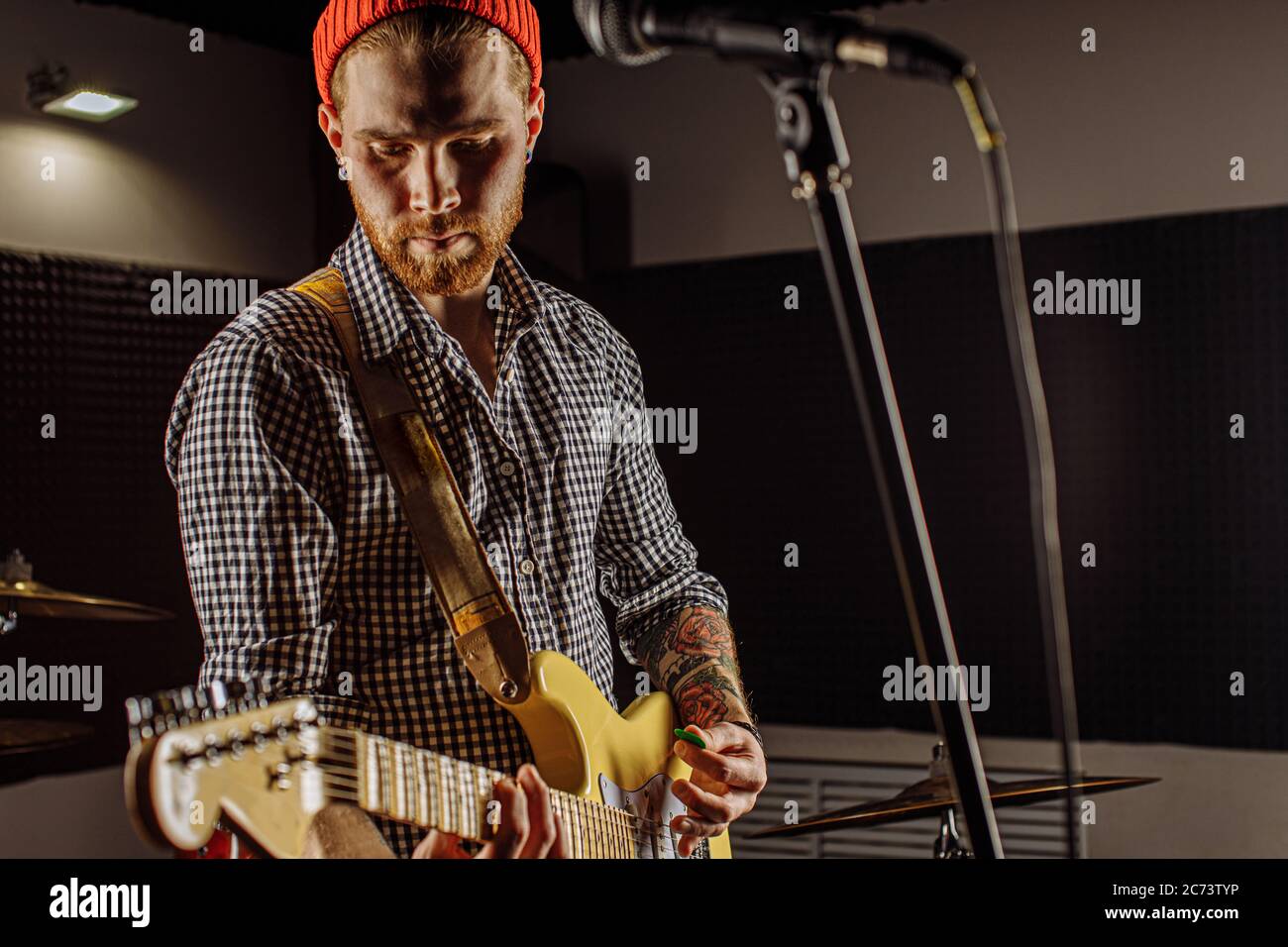 rock and roll. professional musician play electric guitar in studio ...