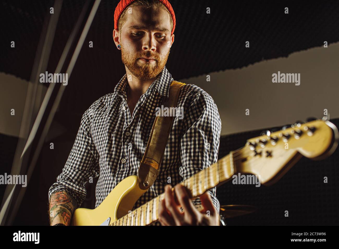 young caucasian rock musician play on electric guitar, man keen on rock ...