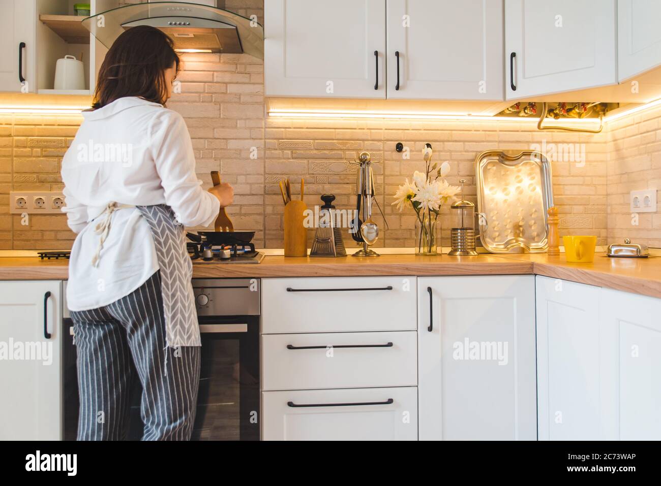 Back view woman cooking in kitchen hi-res stock photography and images ...