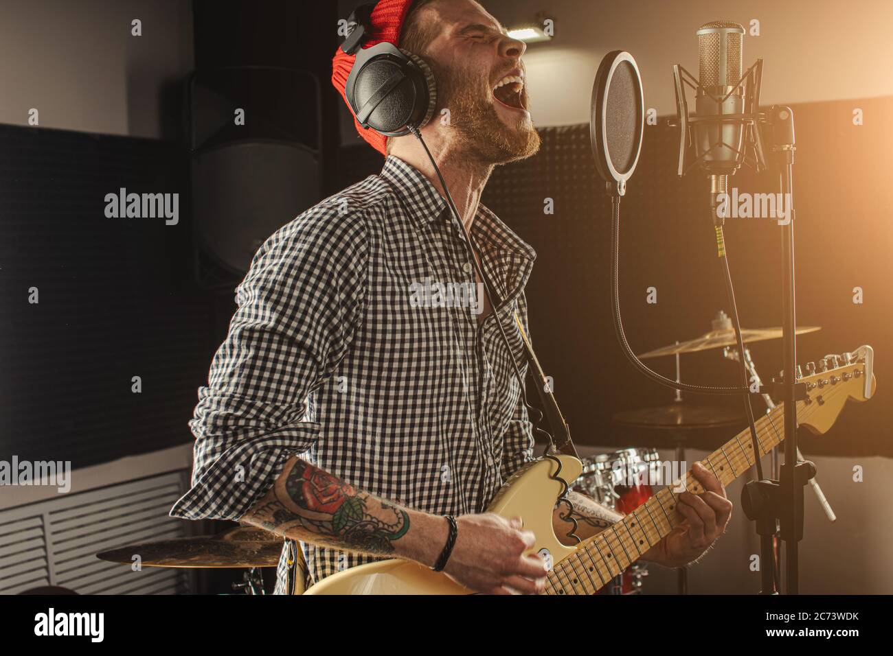 young caucasian gorgeous musician play electric guitar and sing on ...