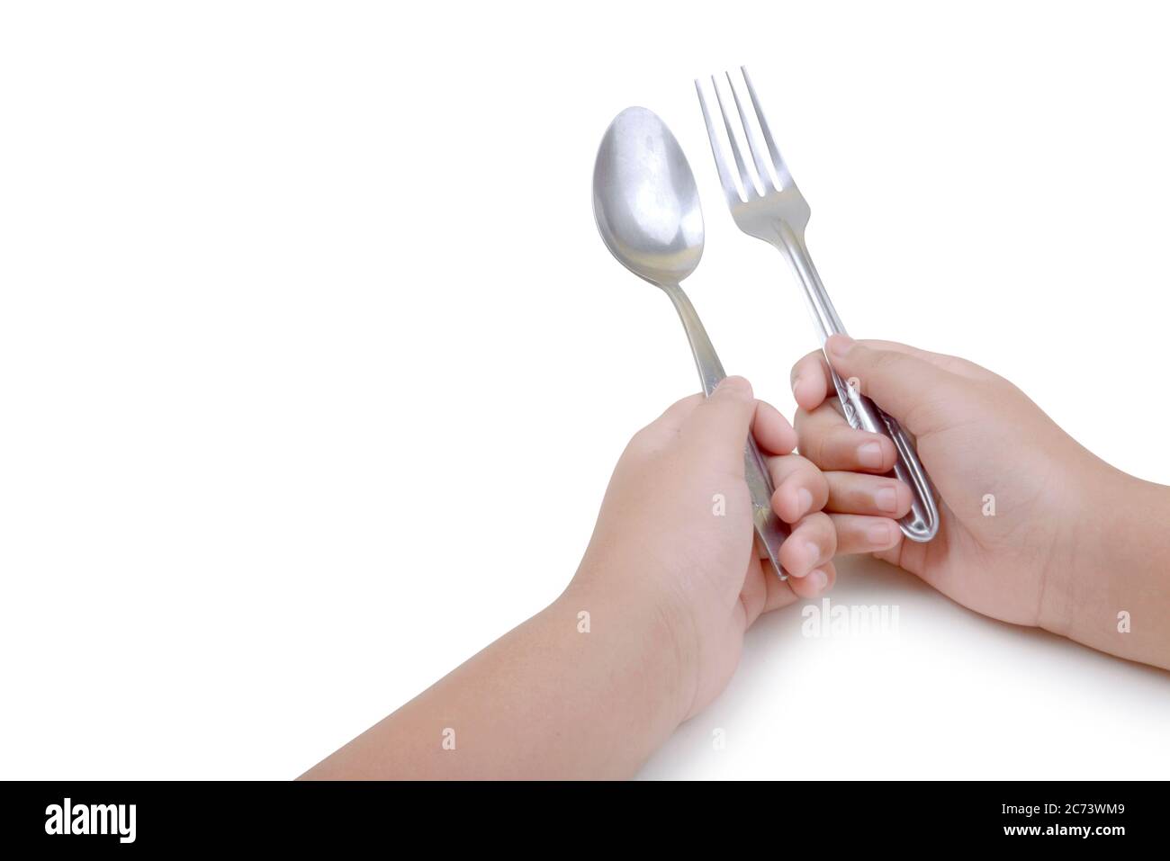 Hand holding silver spoon hi-res stock photography and images - Alamy
