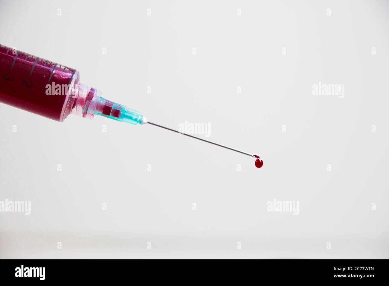 needle injection with blood on the white background. Laboratory test ...