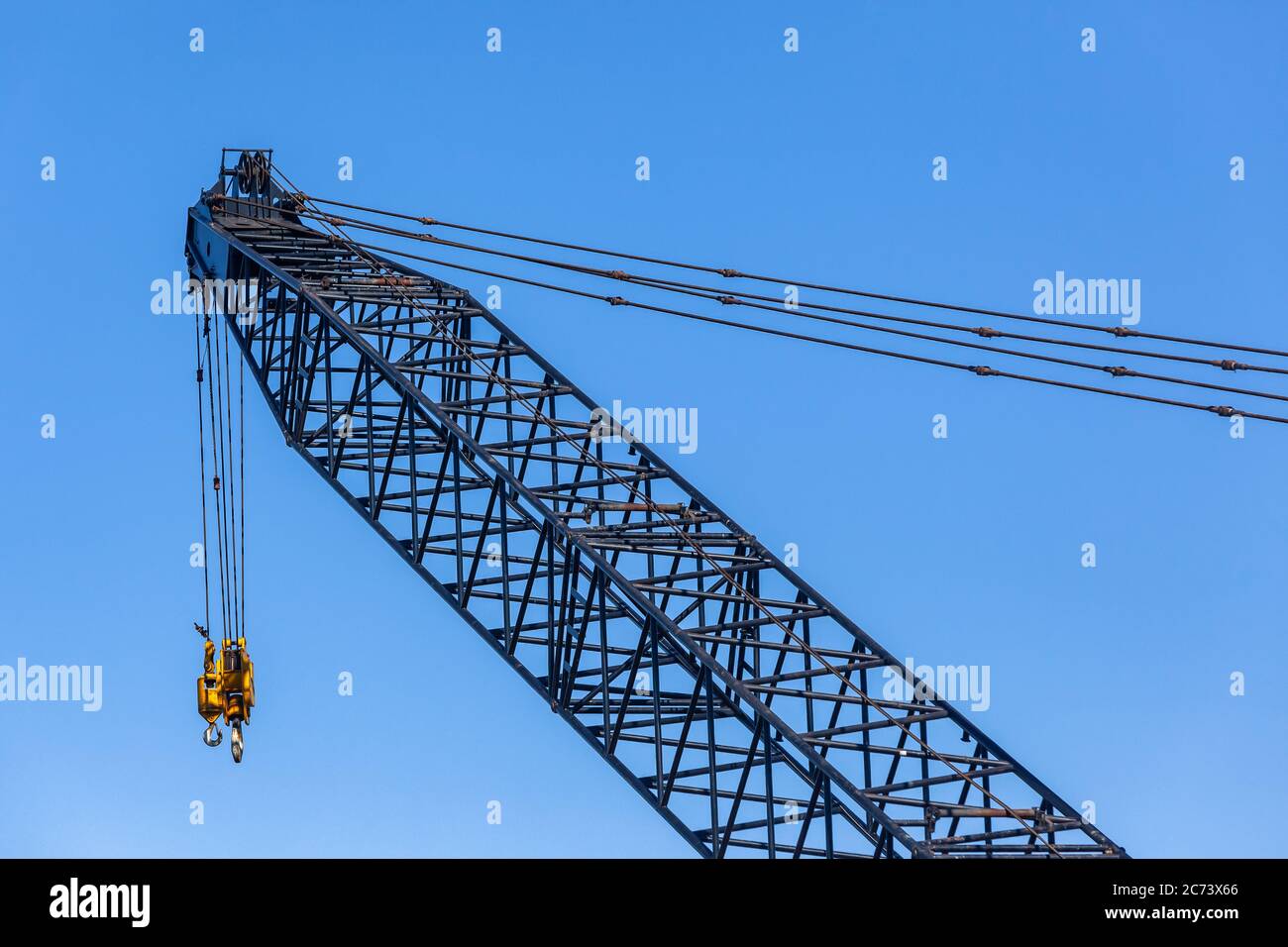 Large rigging crane closeup arm extended section with steel rope cables ...