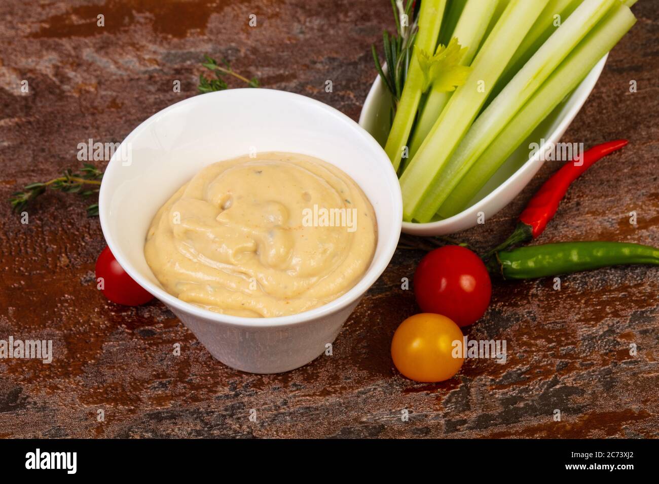 Vegan cuisine - Humus with celery sticks Stock Photo - Alamy