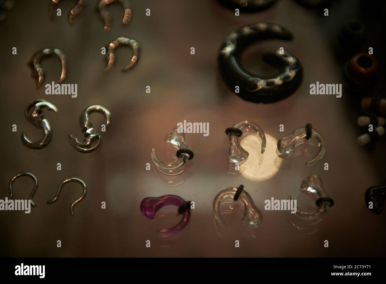 A display case of body piercing jewellery at a tattoo and body piercing ...