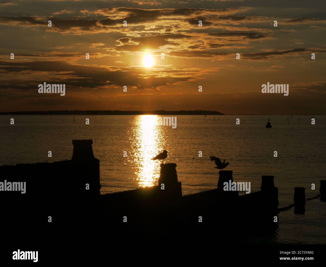 Sunset over Whitstable, Kent, UK, looking towards the Isle of Sheppey ...