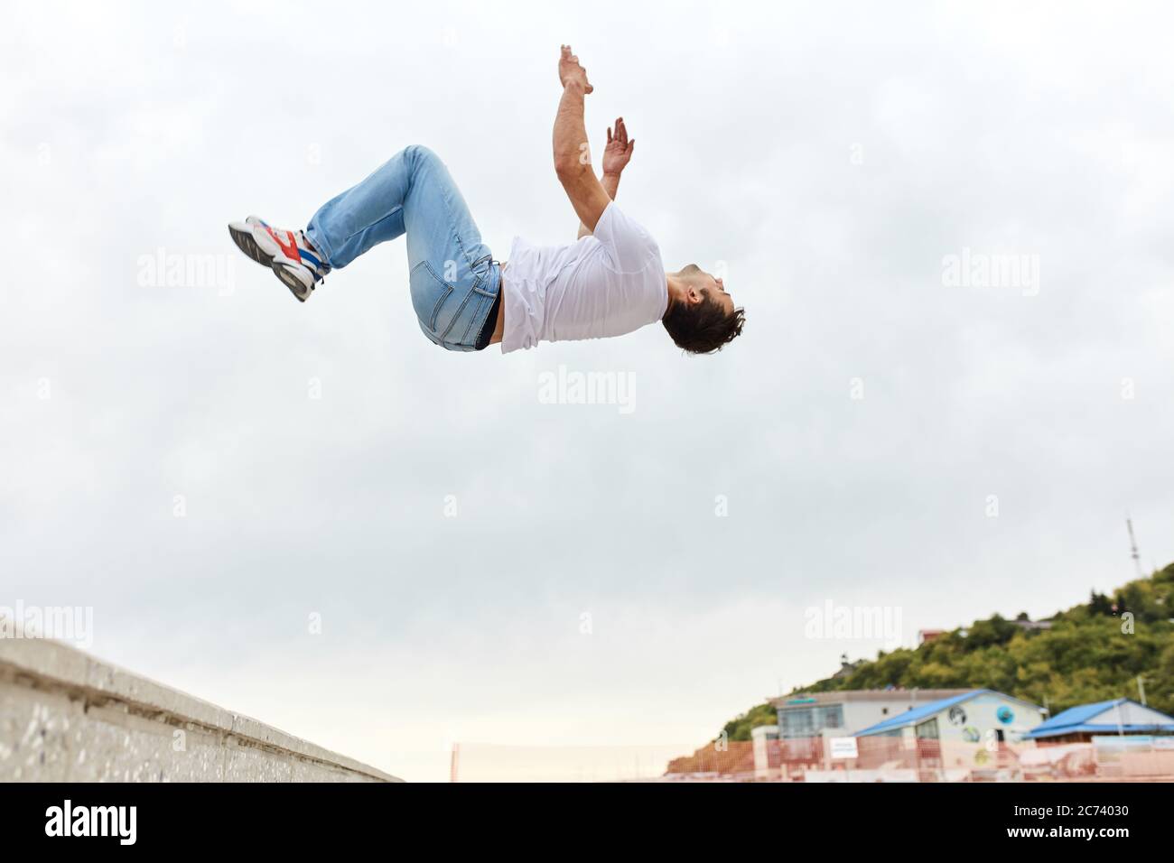 ambitious gymnast turning a somersault, full length side view photo ...