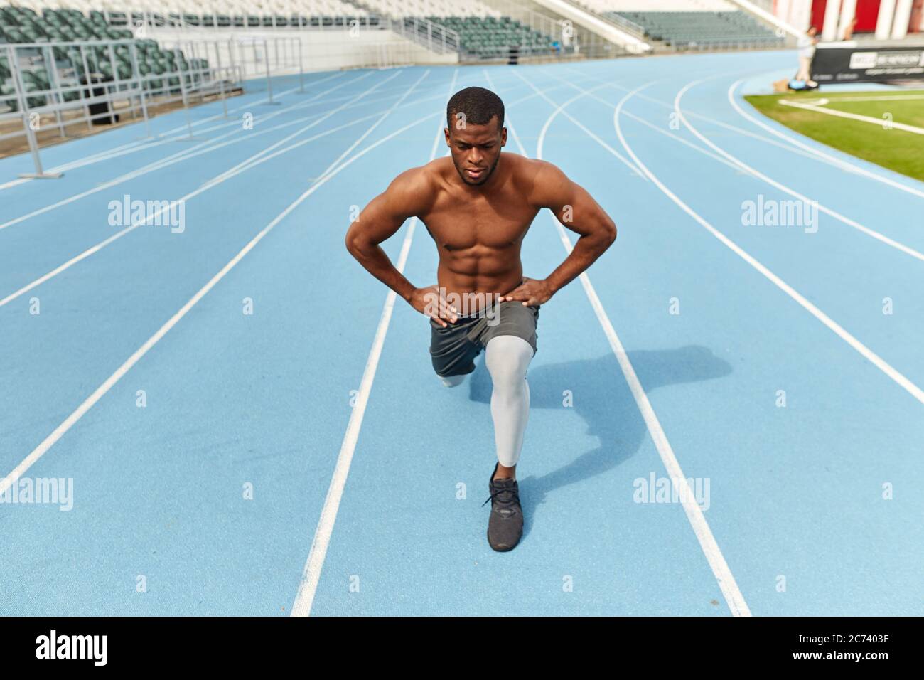 well-built man concentrated on trainig process, full length photo ...
