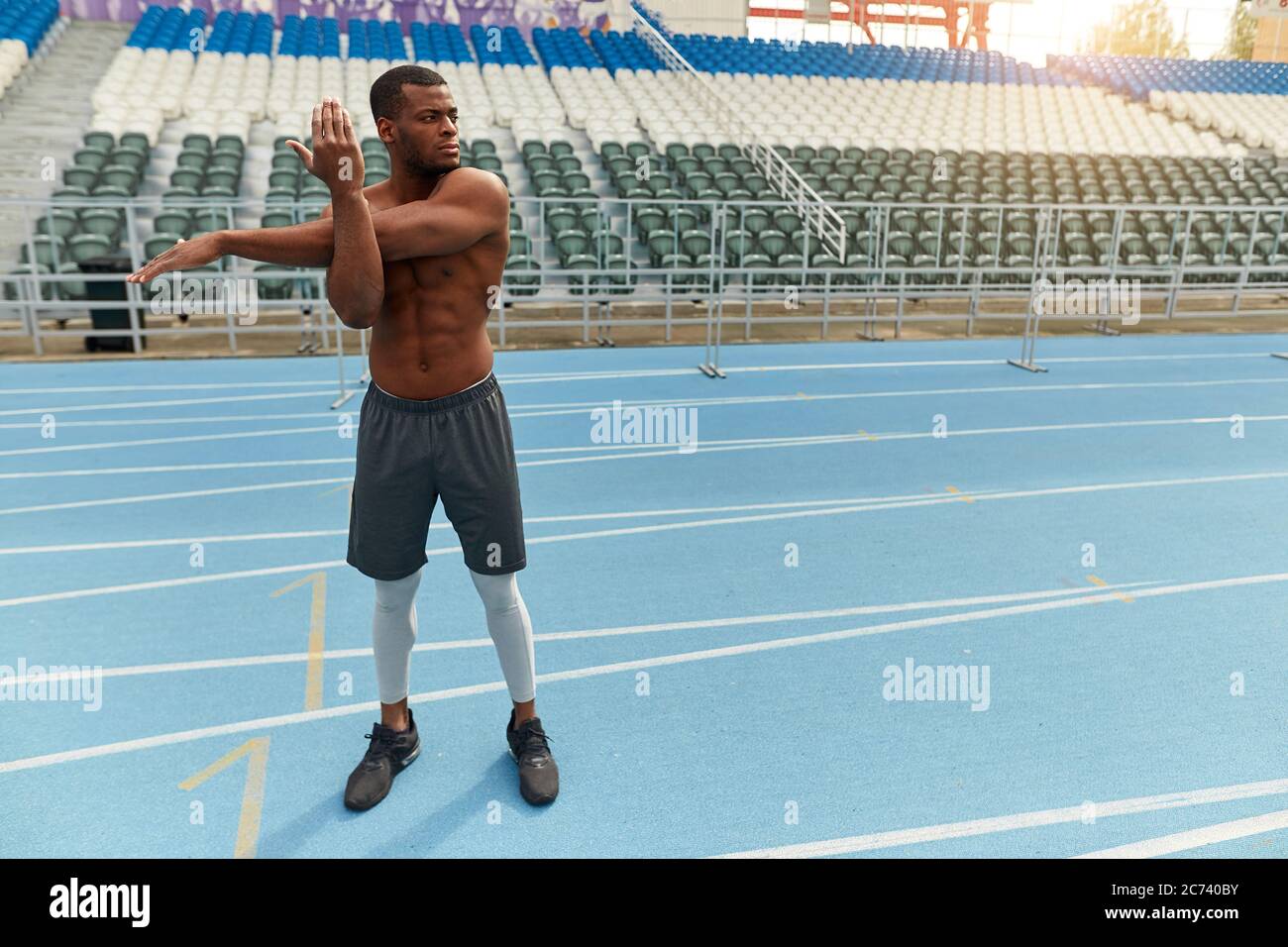 african motivated guy preparing for training, full length photo. copy ...