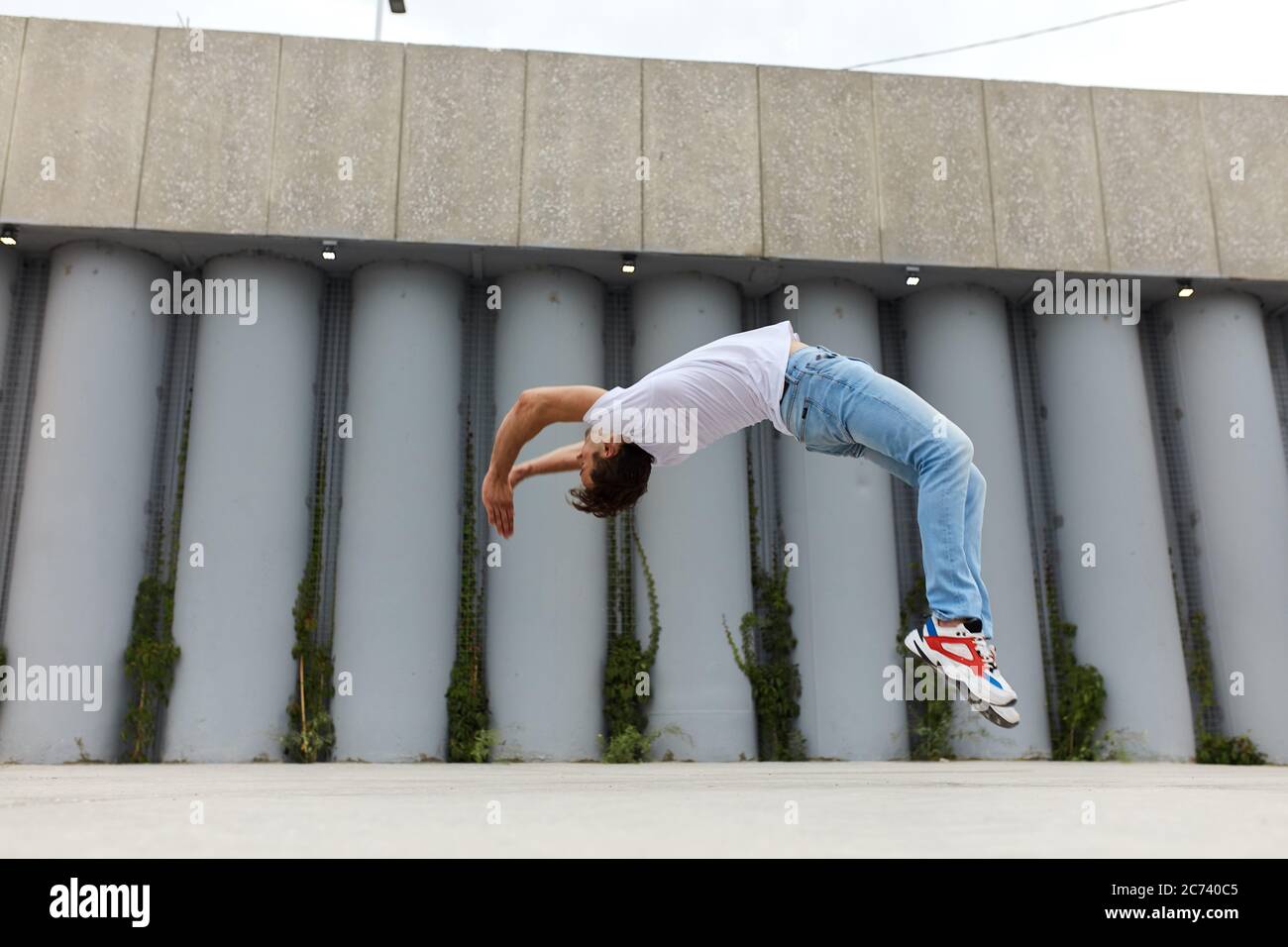brave strong man jumping in the street. full length side view photo ...