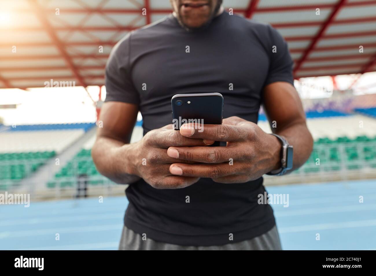 american man looking at the screen of mobile phone, watching films ...