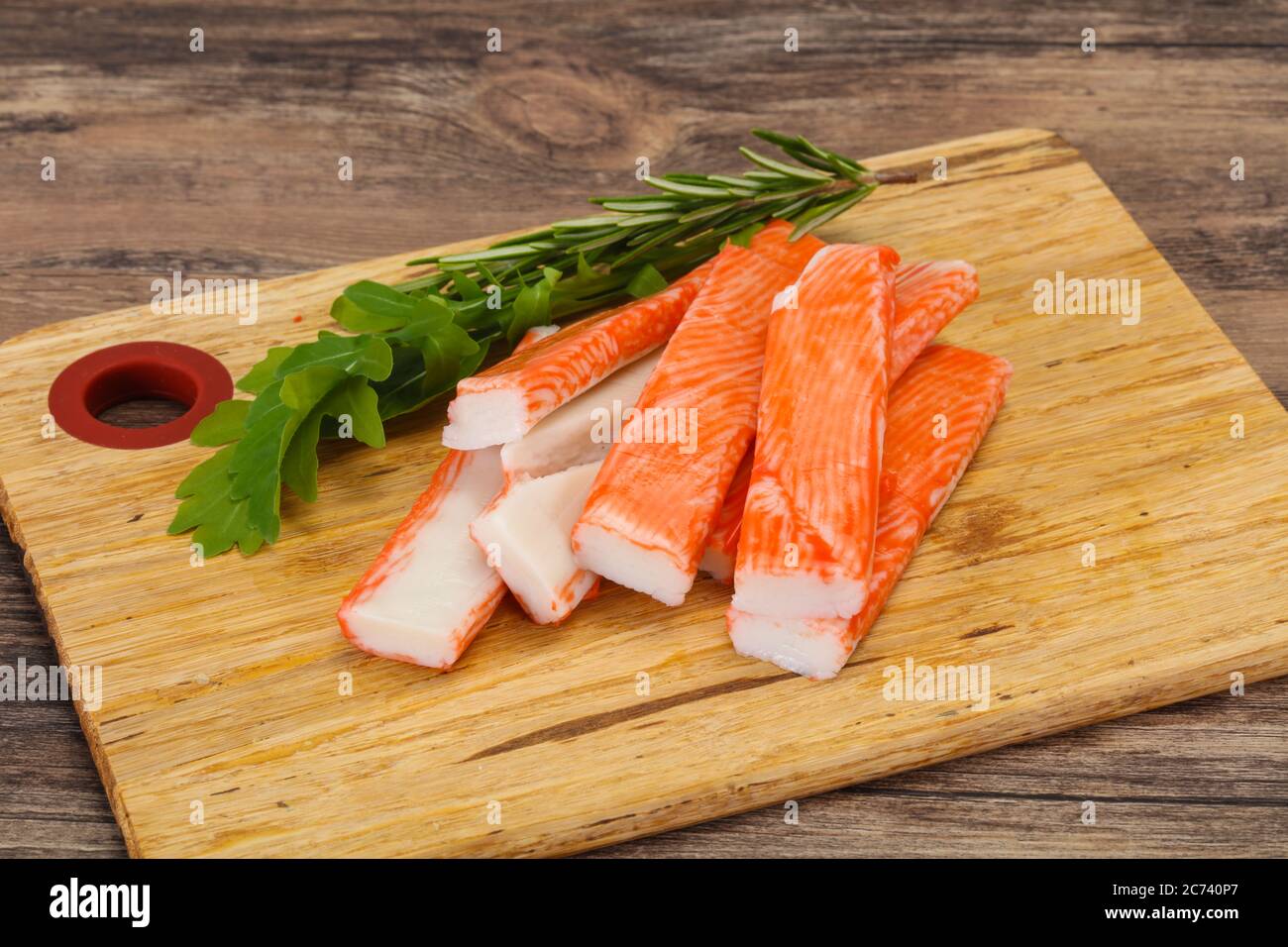 Crab stick surimi over wooden board Stock Photo - Alamy