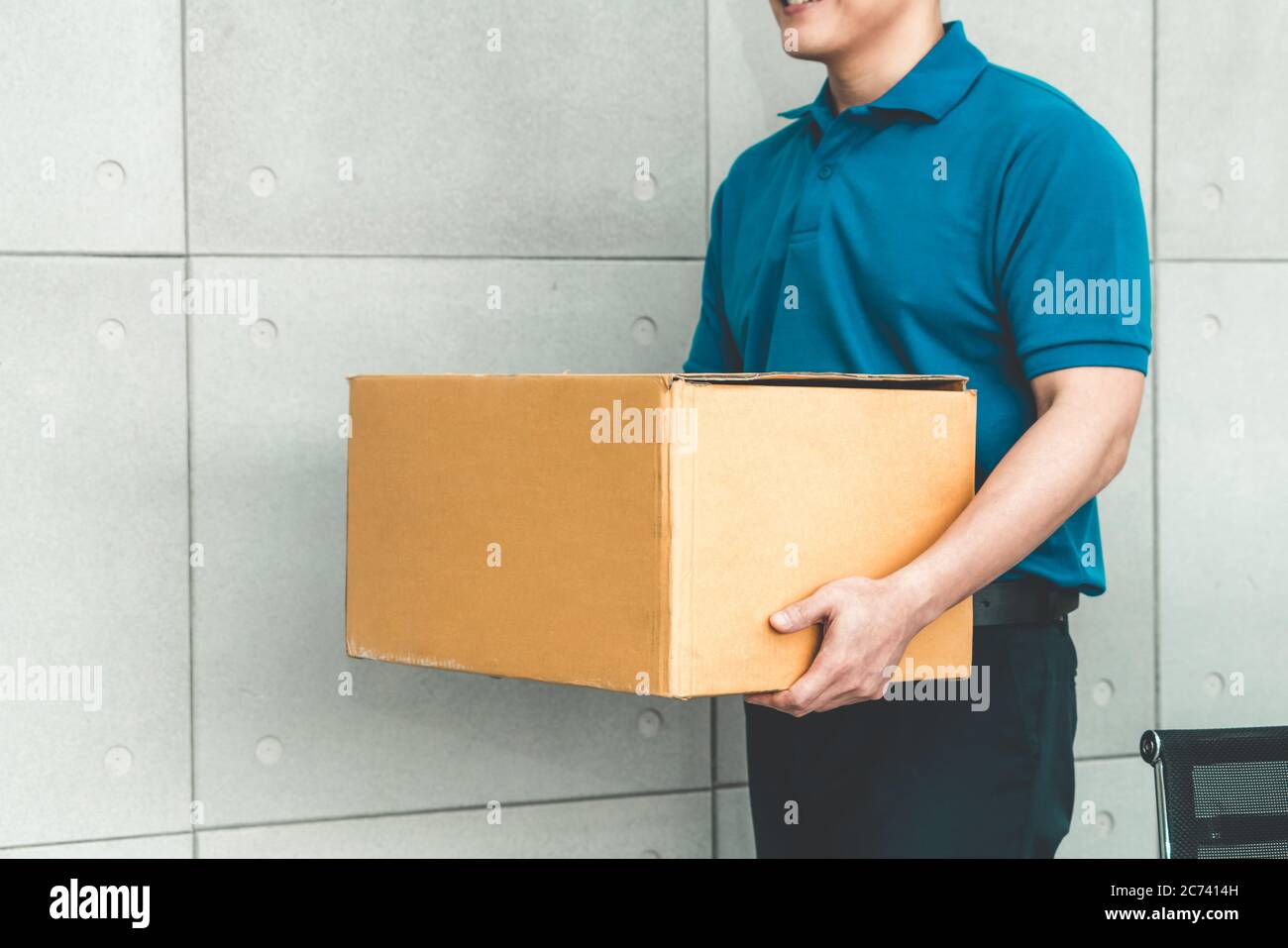 Delivery person carrying parcel box to send to customer Stock Photo - Alamy