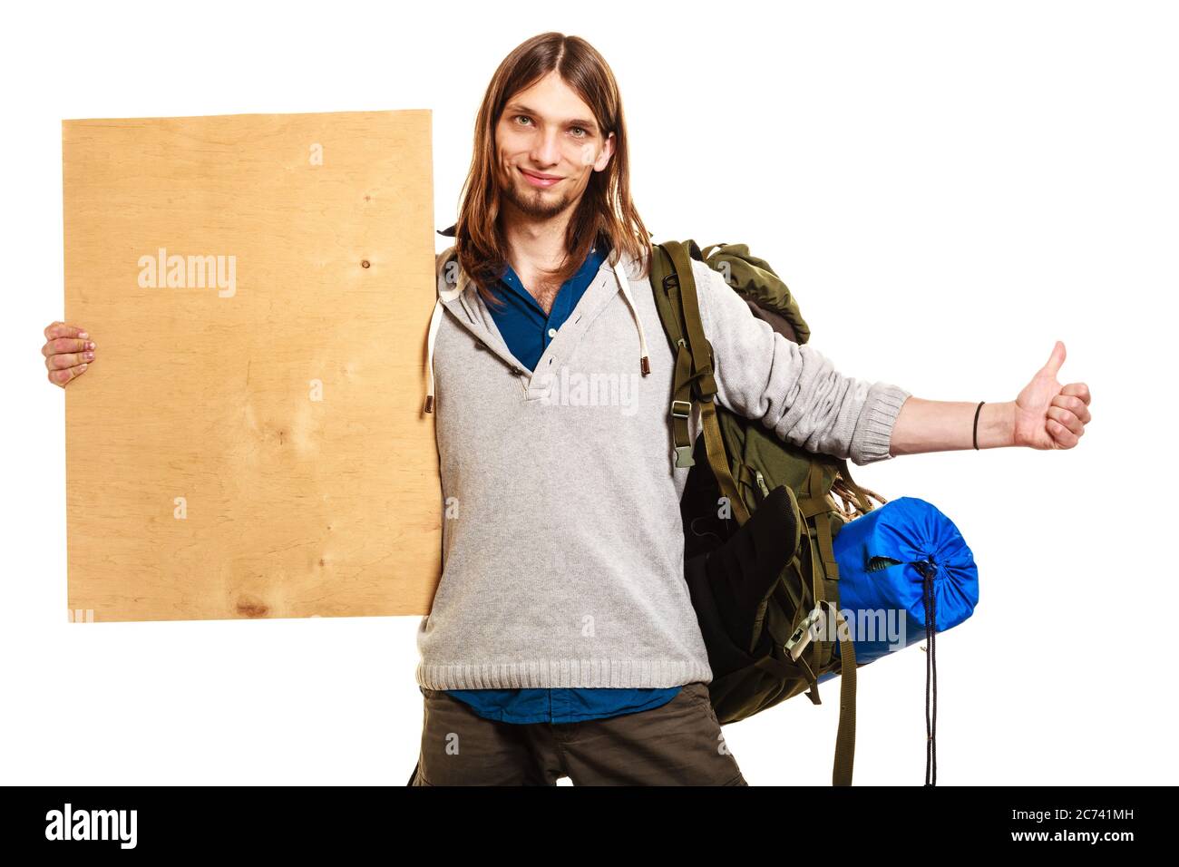 Man tourist backpacker holding blank wood plank copy space. Young guy ...