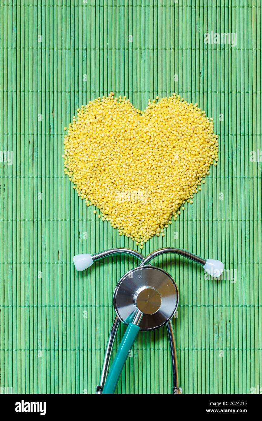 Dieting healthy living concept. Millet groats heart shaped and ...