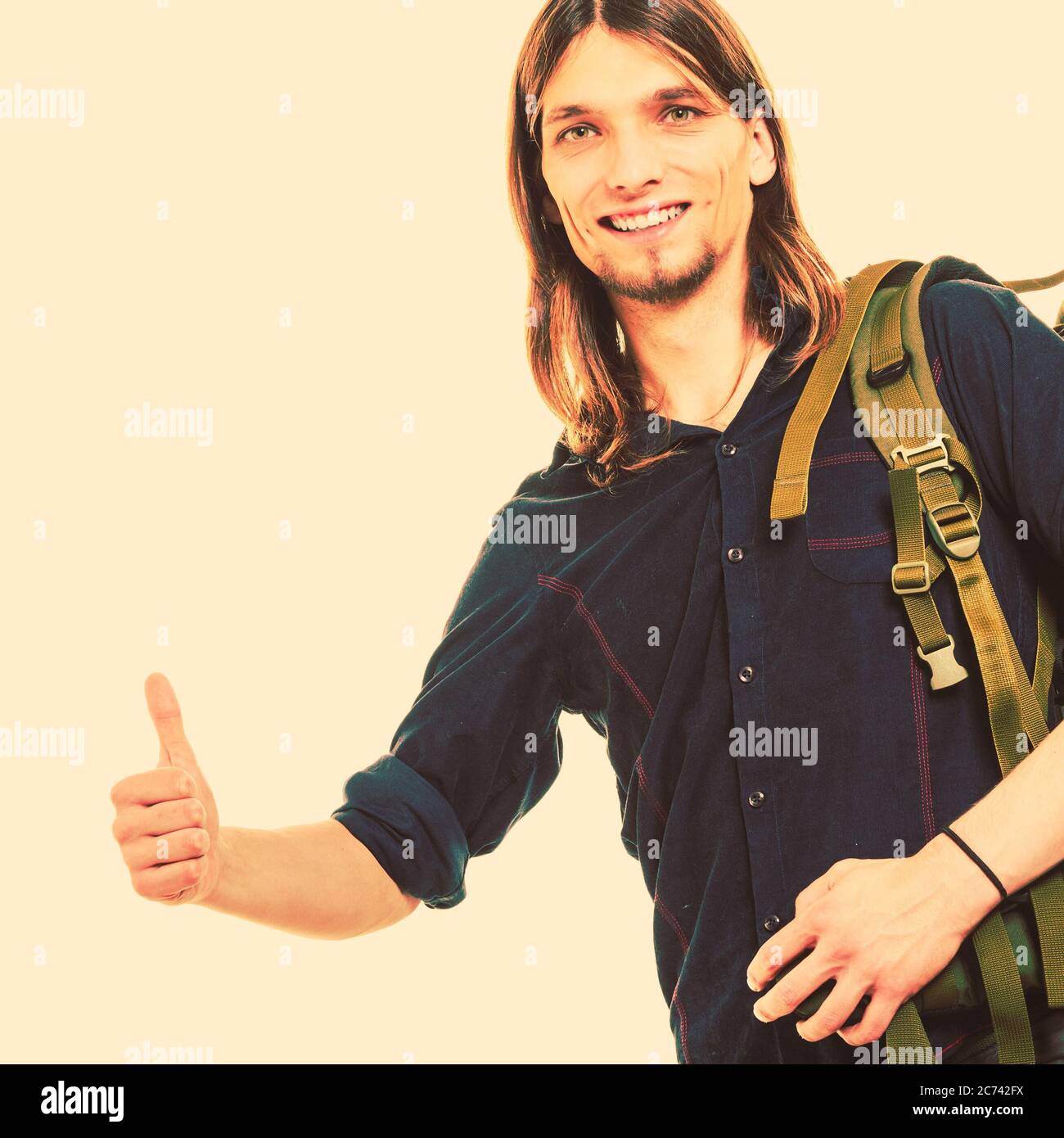 Man tourist hitchhiker. Young guy hitchhiking with thumb up gesture ...