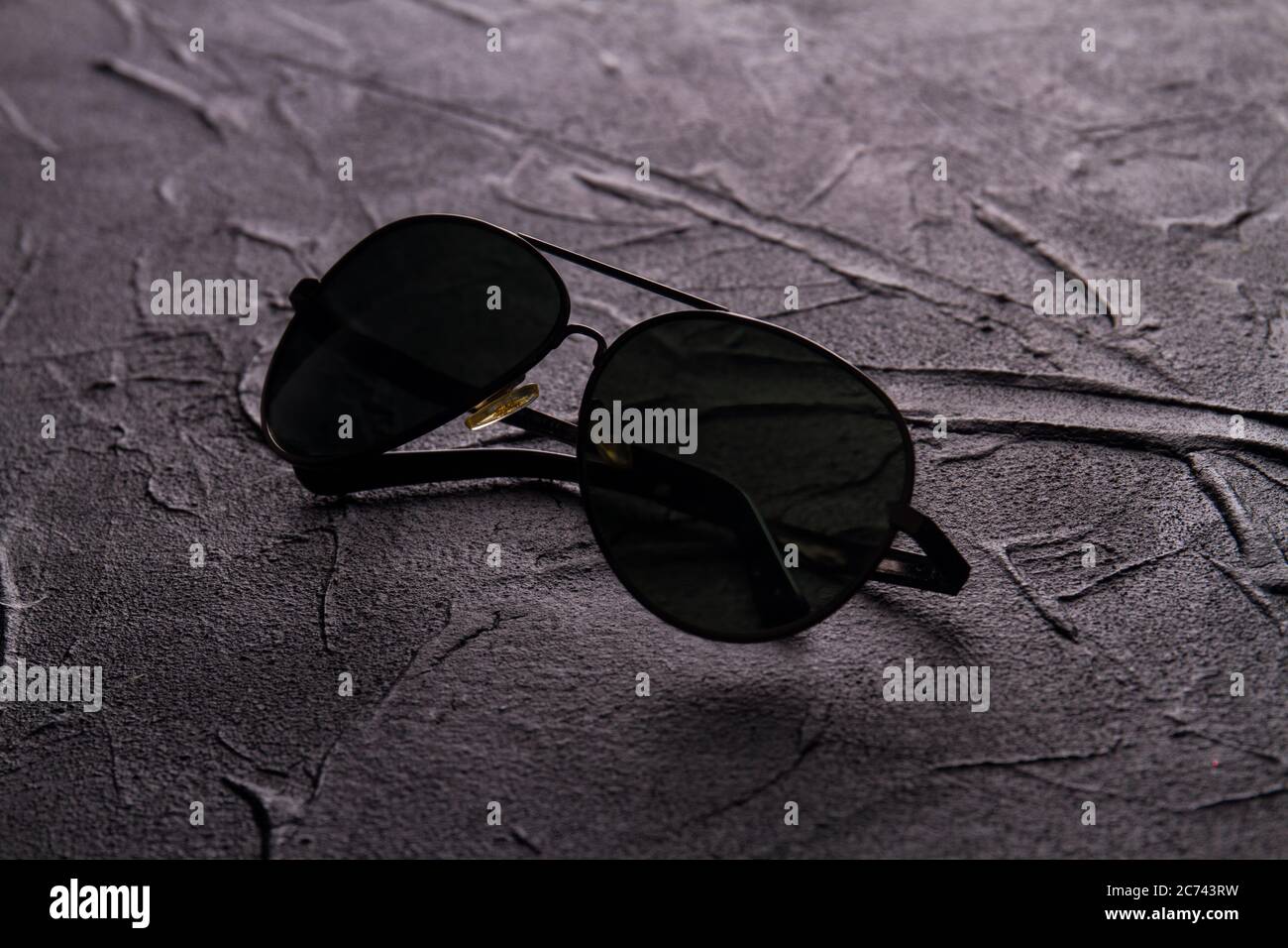 Black sunglasses on a dark raised surface Stock Photo - Alamy