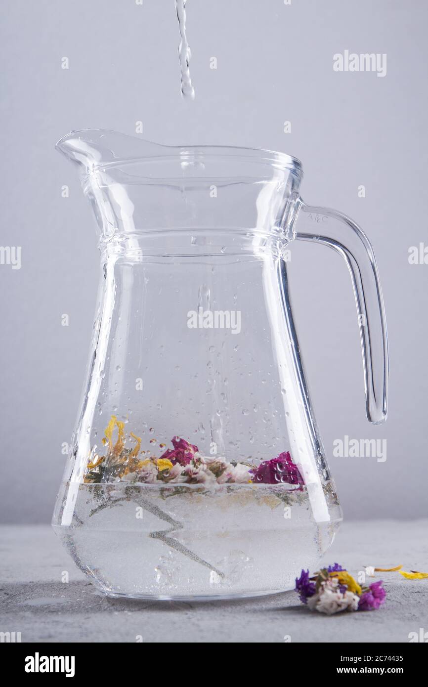 Dripping water into glass hug Stock Photo - Alamy