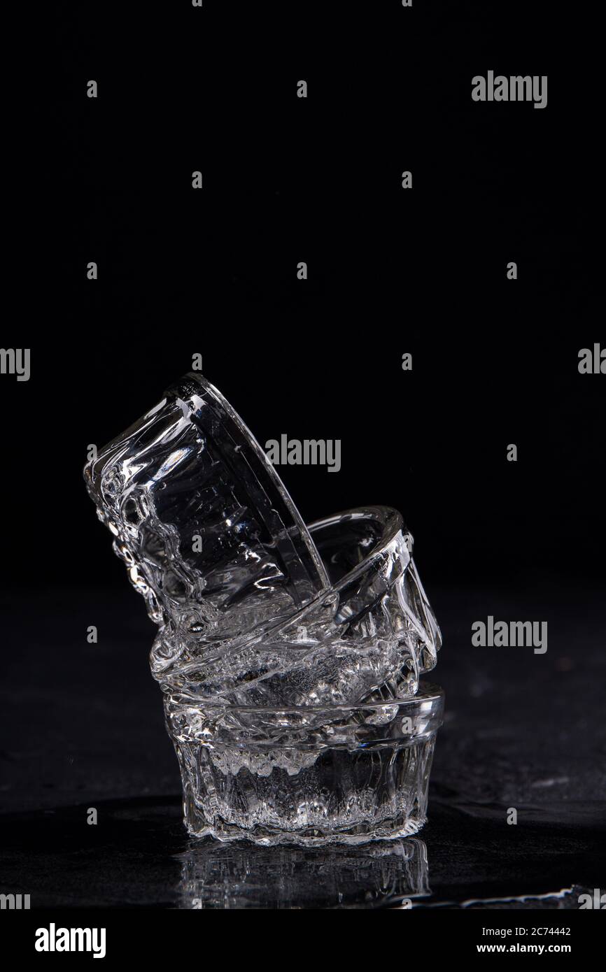 Stack of small glass cups filled with mineral water Stock Photo - Alamy