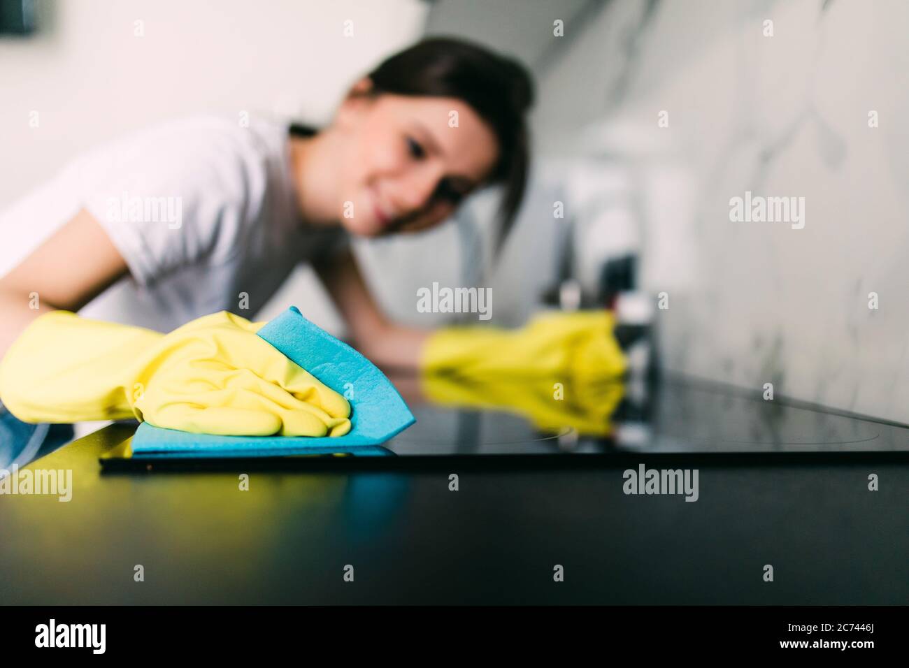 people, housework and housekeeping concept - happy woman cleaning table ...