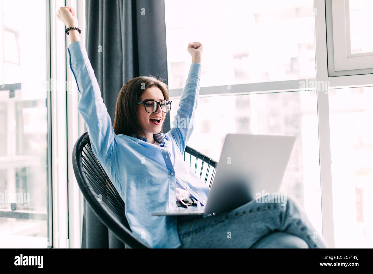 Enjoying relaxing time after work at home. Beautiful young smiling ...