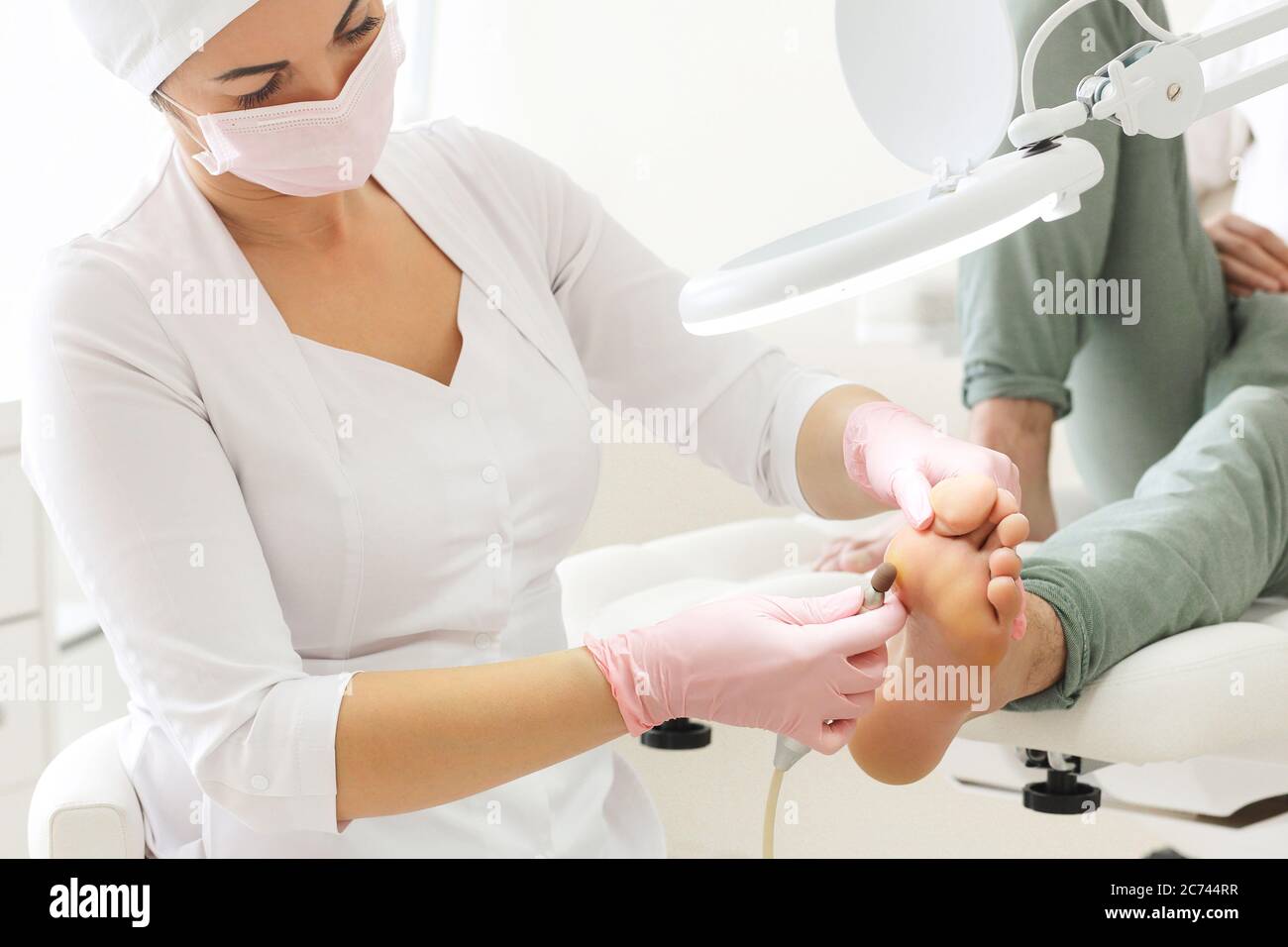 Patient on medical pedicure procedure, visiting podiatrist.Professional ...