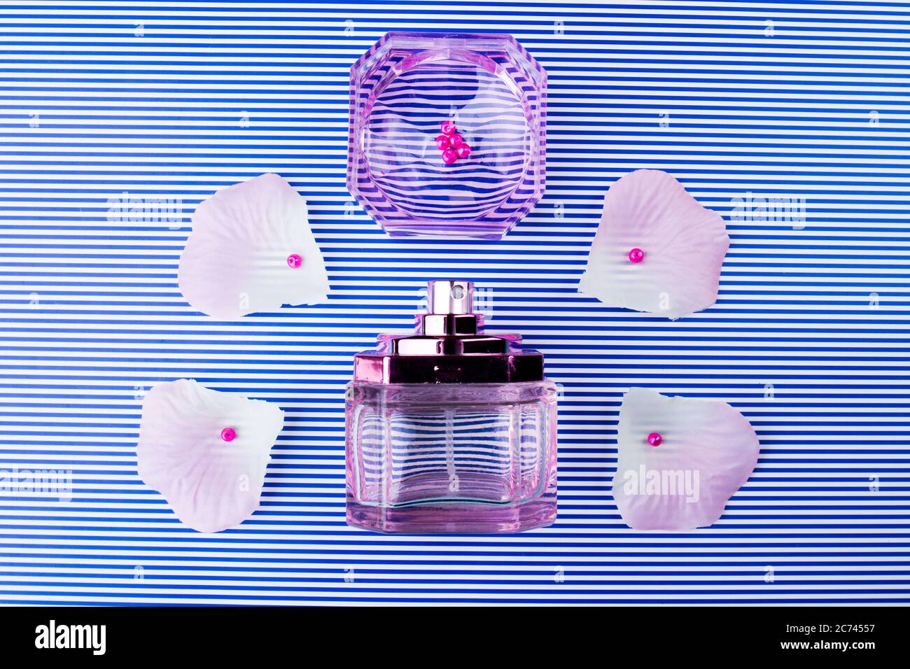 Composition of bottle of perfume with flower petals Stock Photo - Alamy