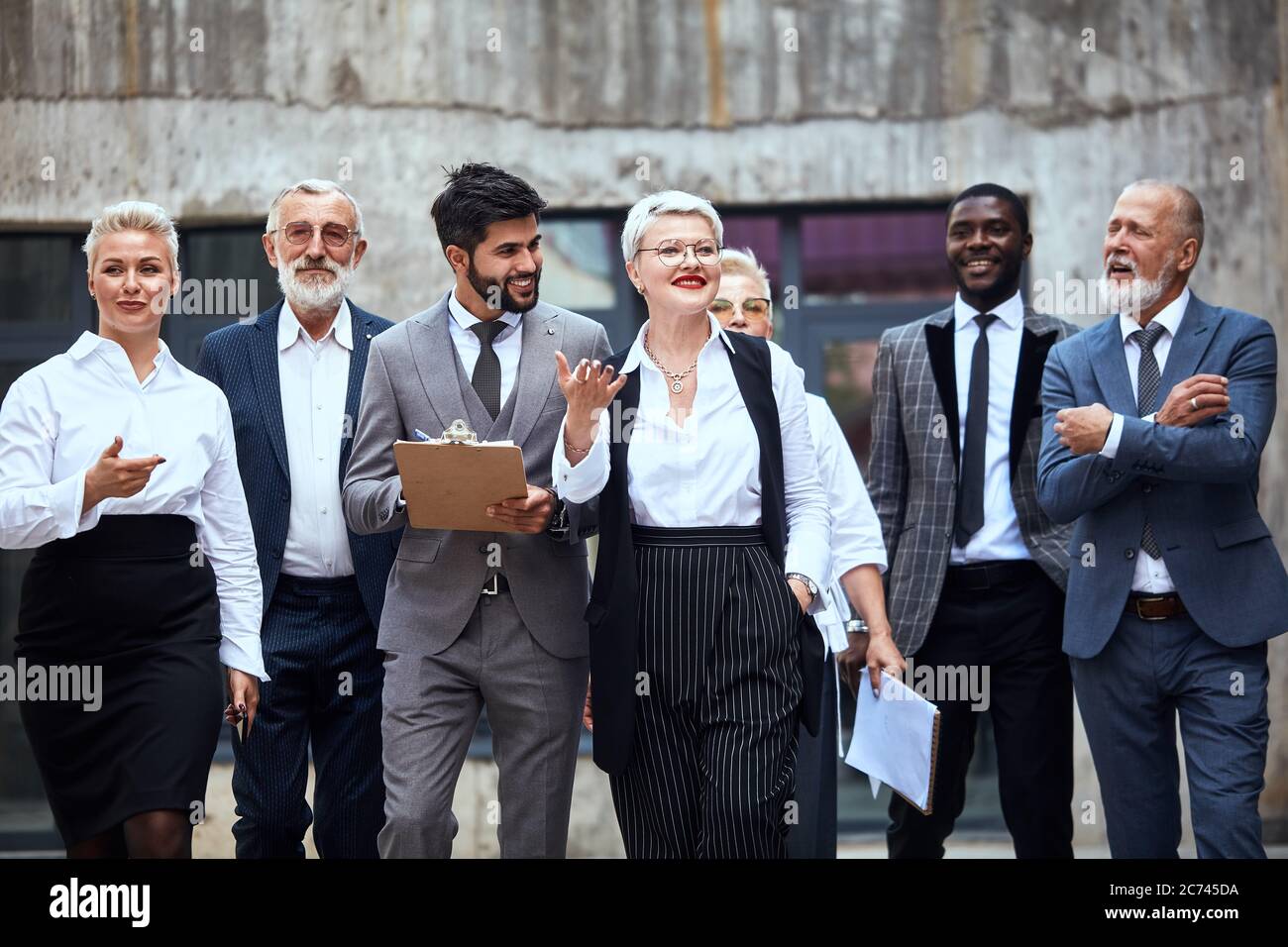 Six caucasian and one african businessmen dressed in stylish office ...