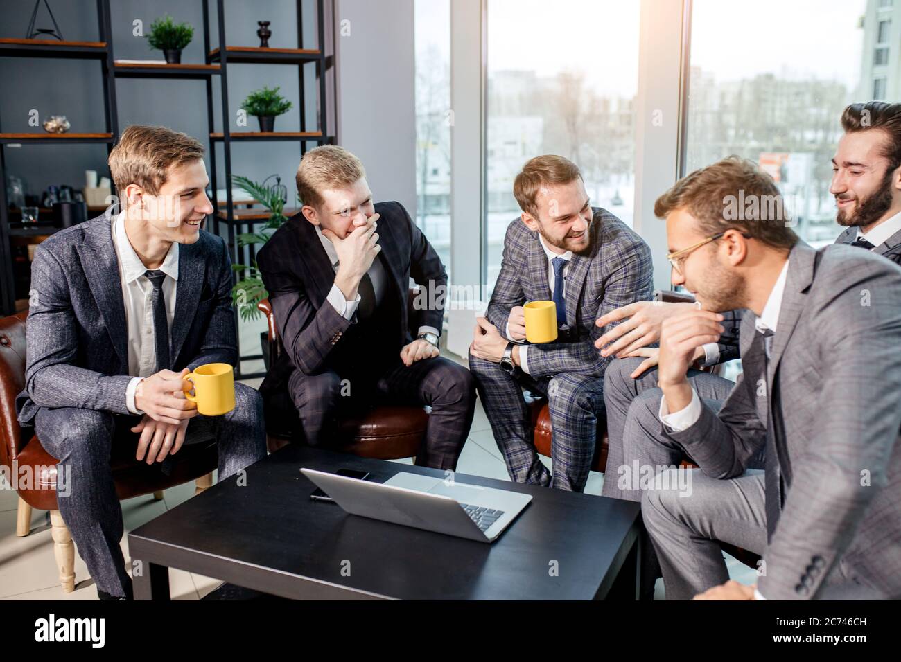 leisure time of male business team gathered in modern executive office ...