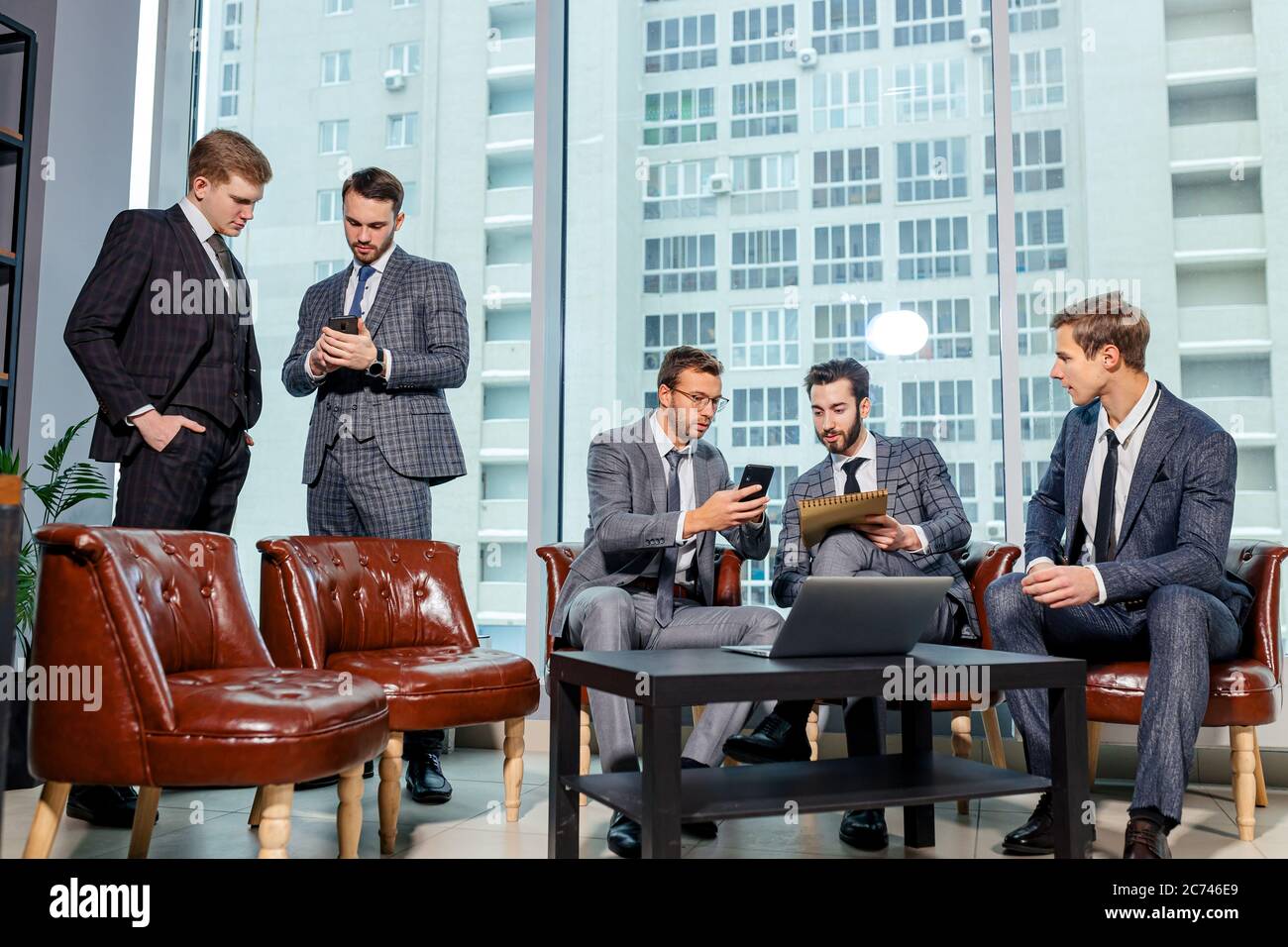 teamwork of young business men gathered in modern office with big ...