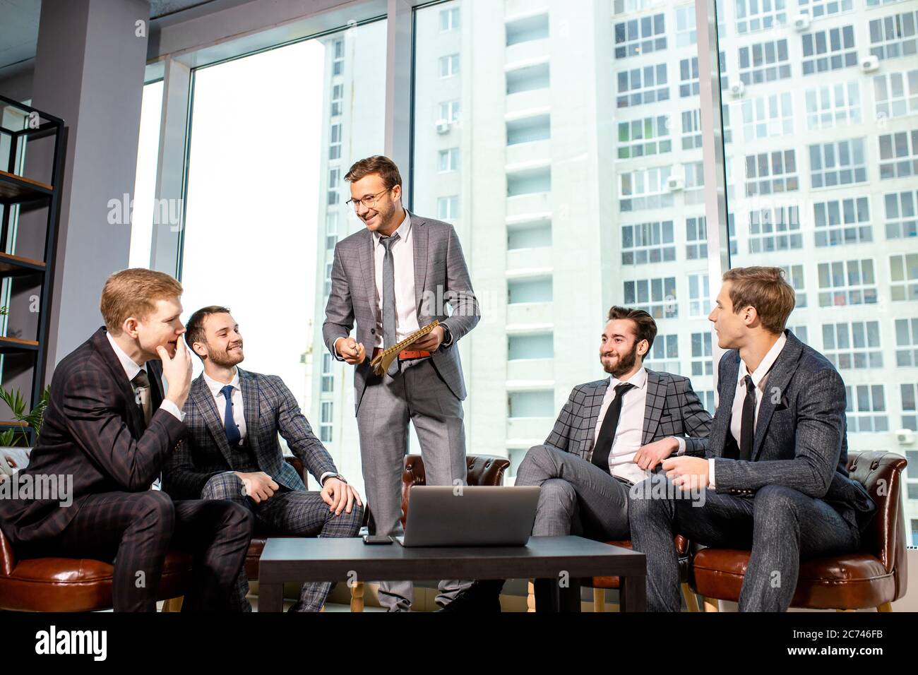 young business guys in formalwear, in tuxedo work in office together ...