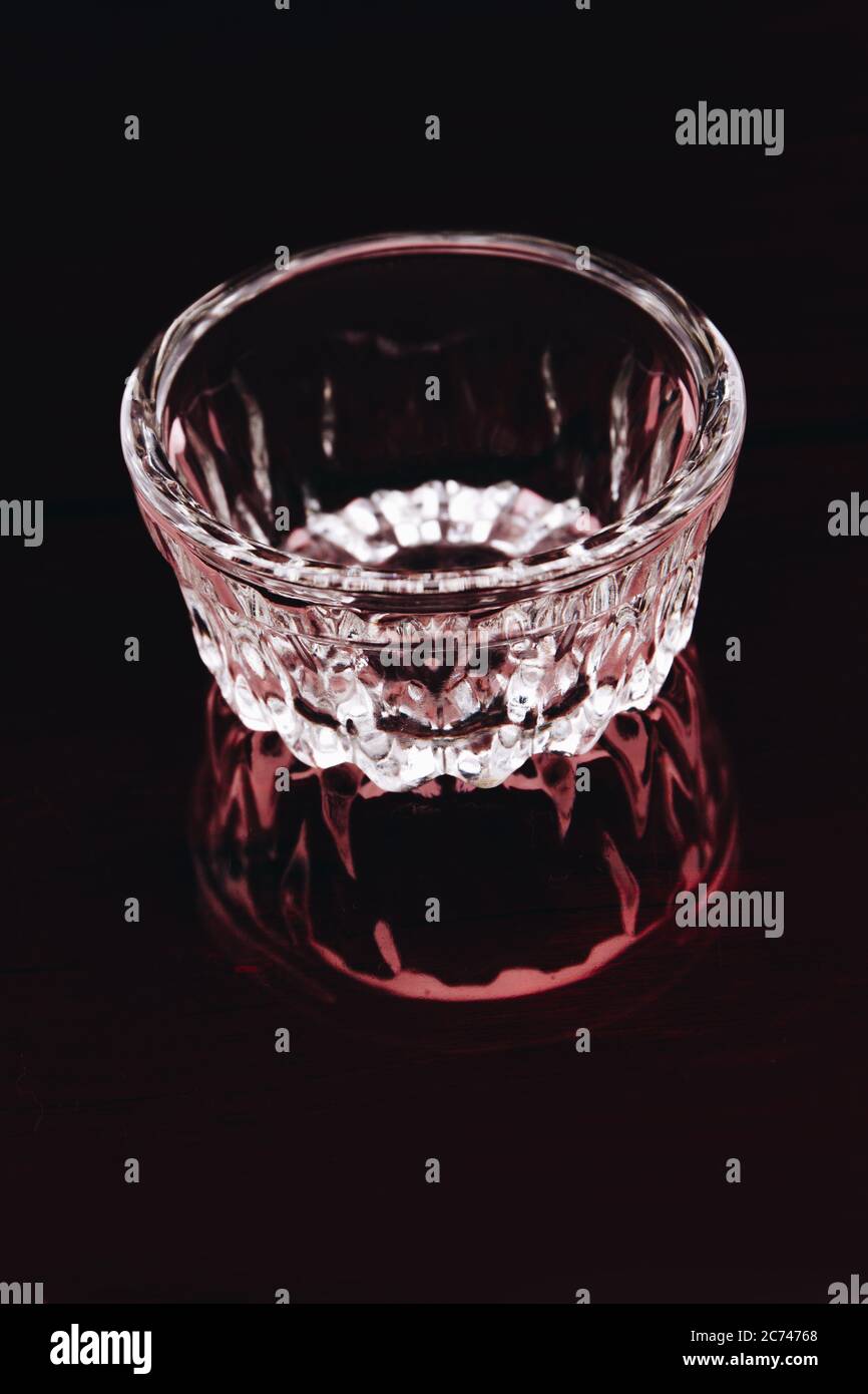 Glass bowl on black background and reflective surface Stock Photo - Alamy