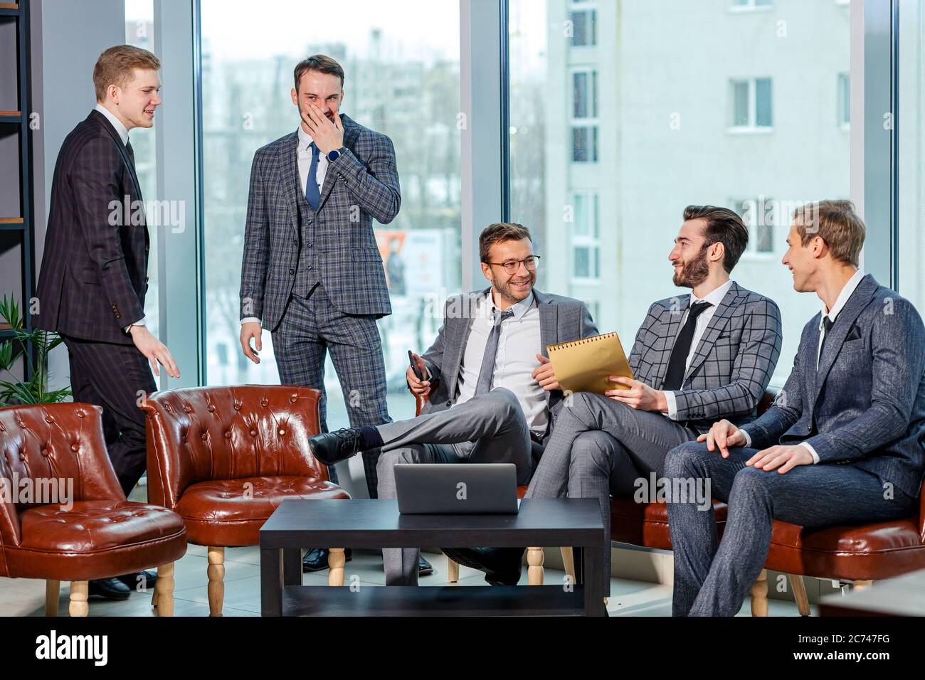 togetherness and partnership of young caucasian business men at work ...