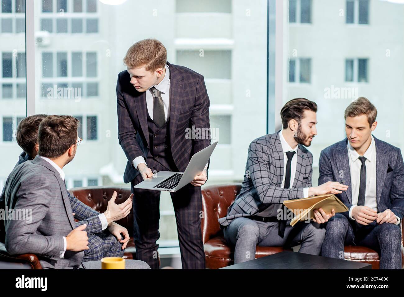 teamwork of young business men gathered in modern office with big ...