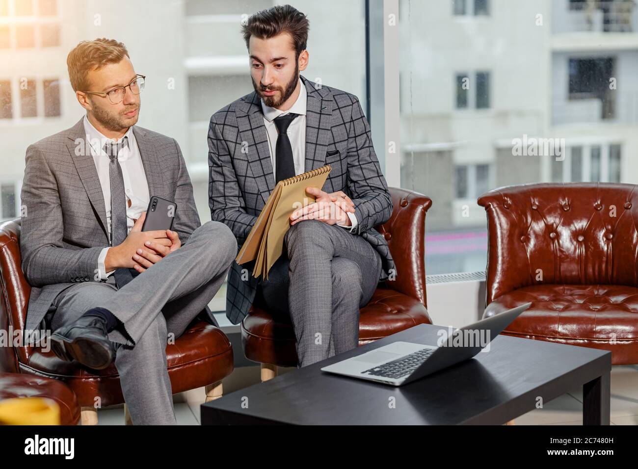 togetherness and partnership of young caucasian business men at work ...