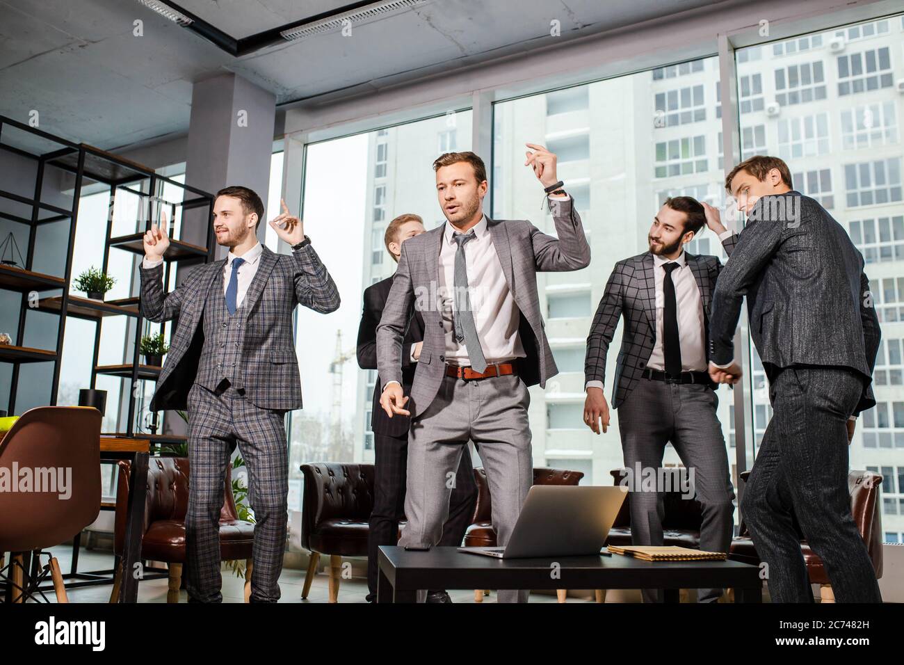happy positive cheerful business team dance after meeting, celebrate in ...