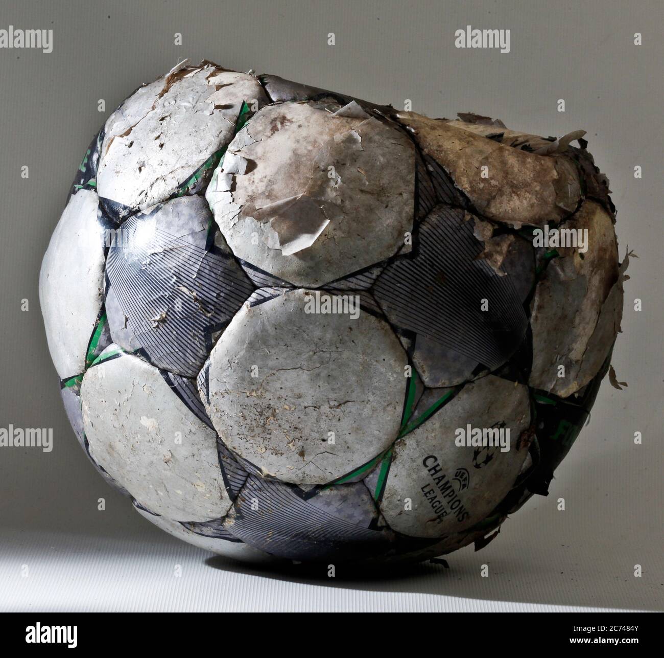 Damaged soccer ball Stock Photo - Alamy