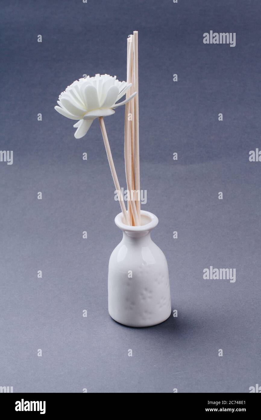 Spa flower in a white vase on grey background Stock Photo - Alamy