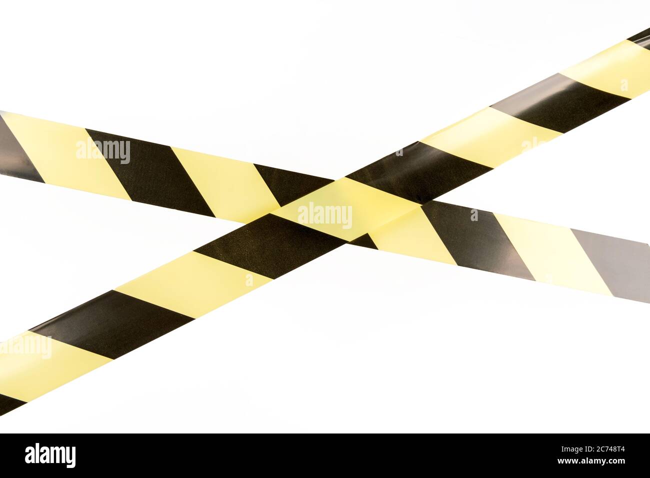 Black and yellow restrictive tape on a white background. The tape is ...