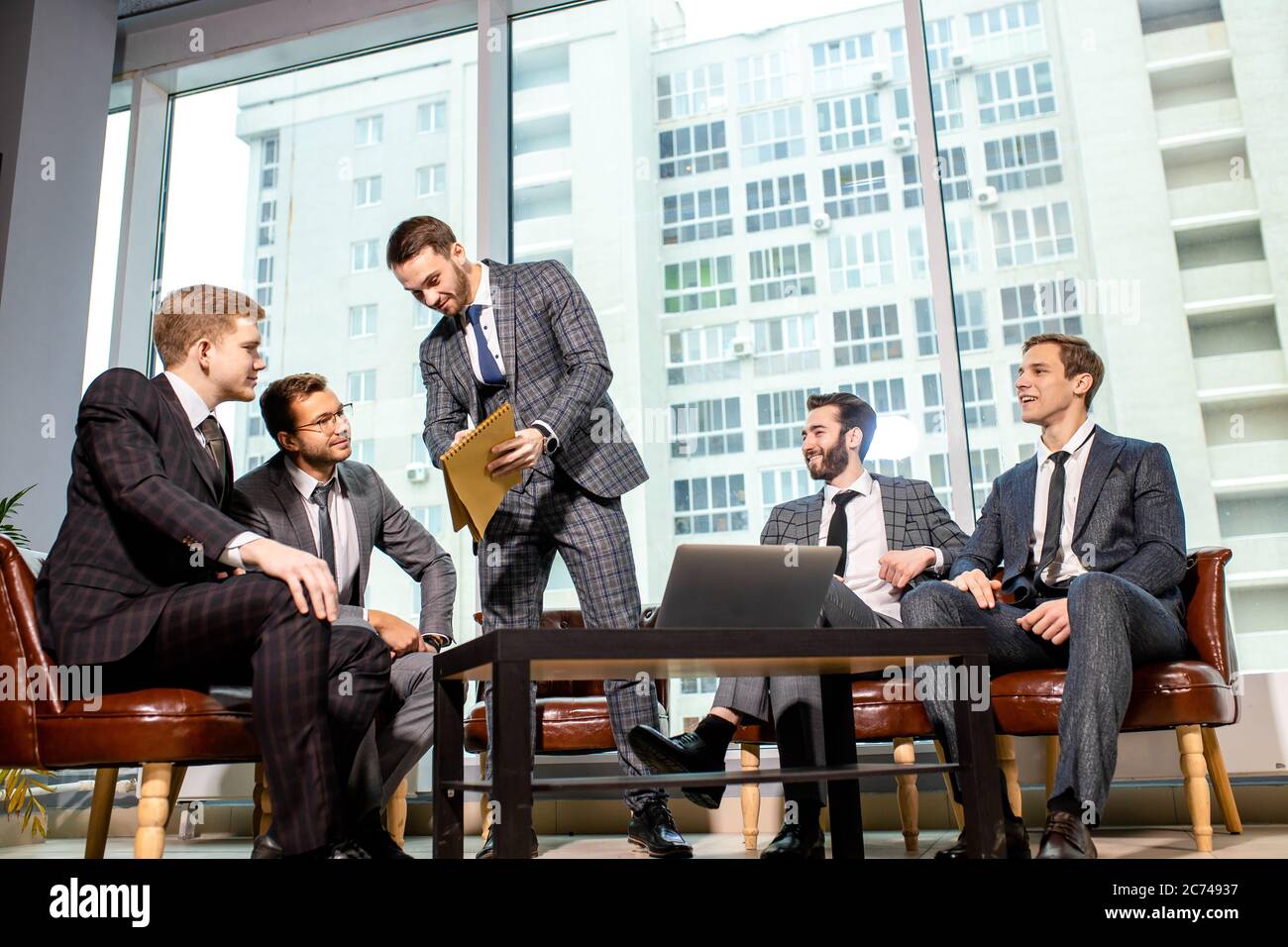 togetherness and partnership of young caucasian business men at work ...