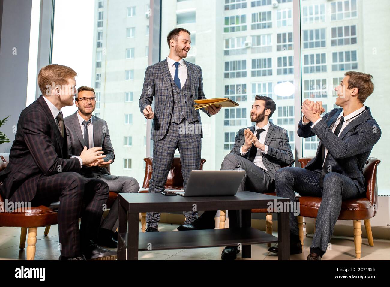 teamwork of young business men gathered in modern office with big ...