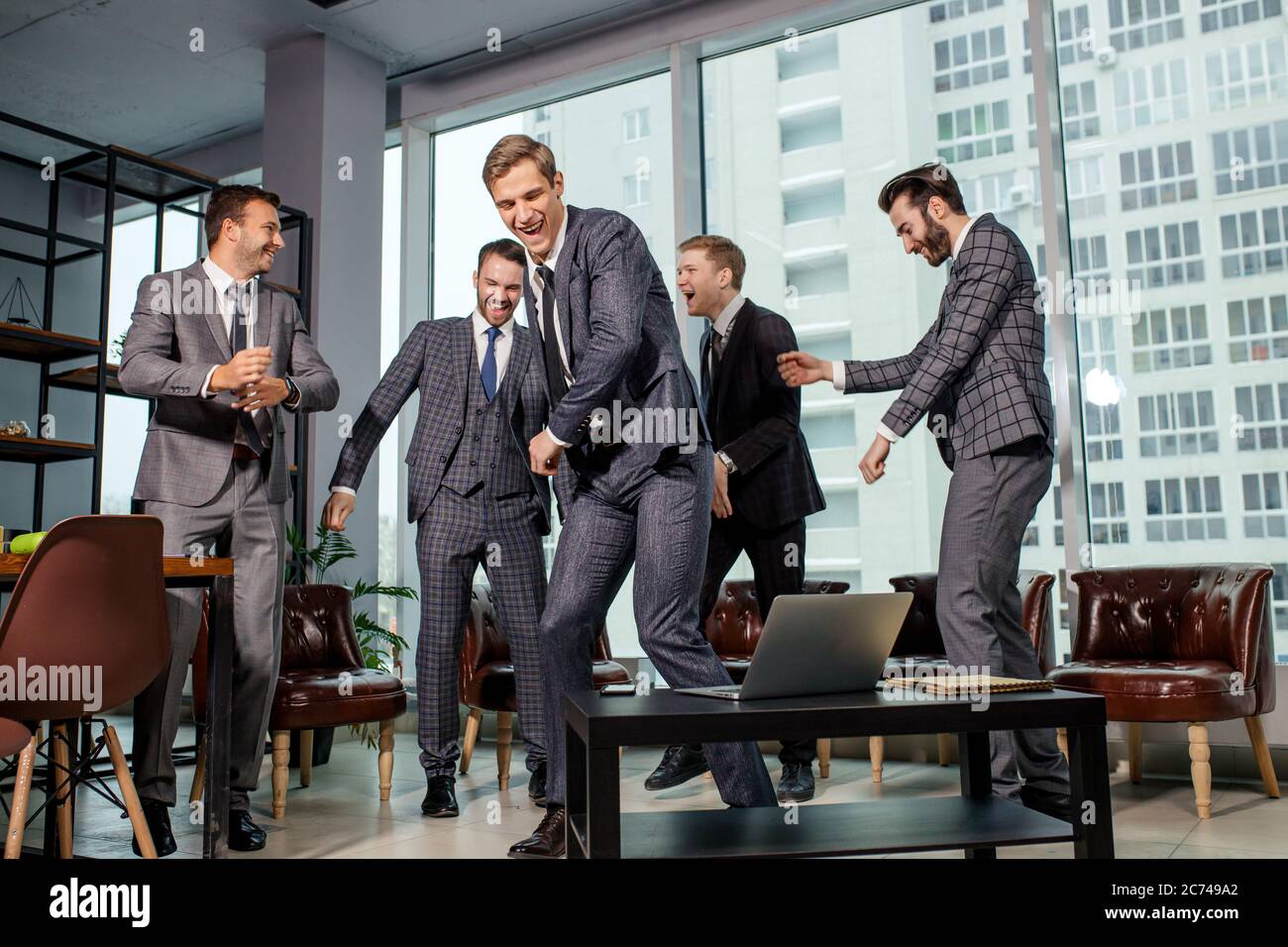 dancing happy business men after meeting in office, enjoy work together ...