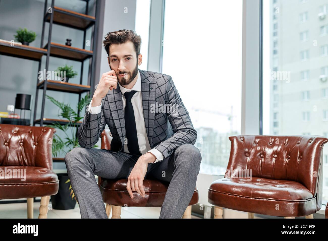 portrait of young caucasian business man in tuxedo confidently looking ...