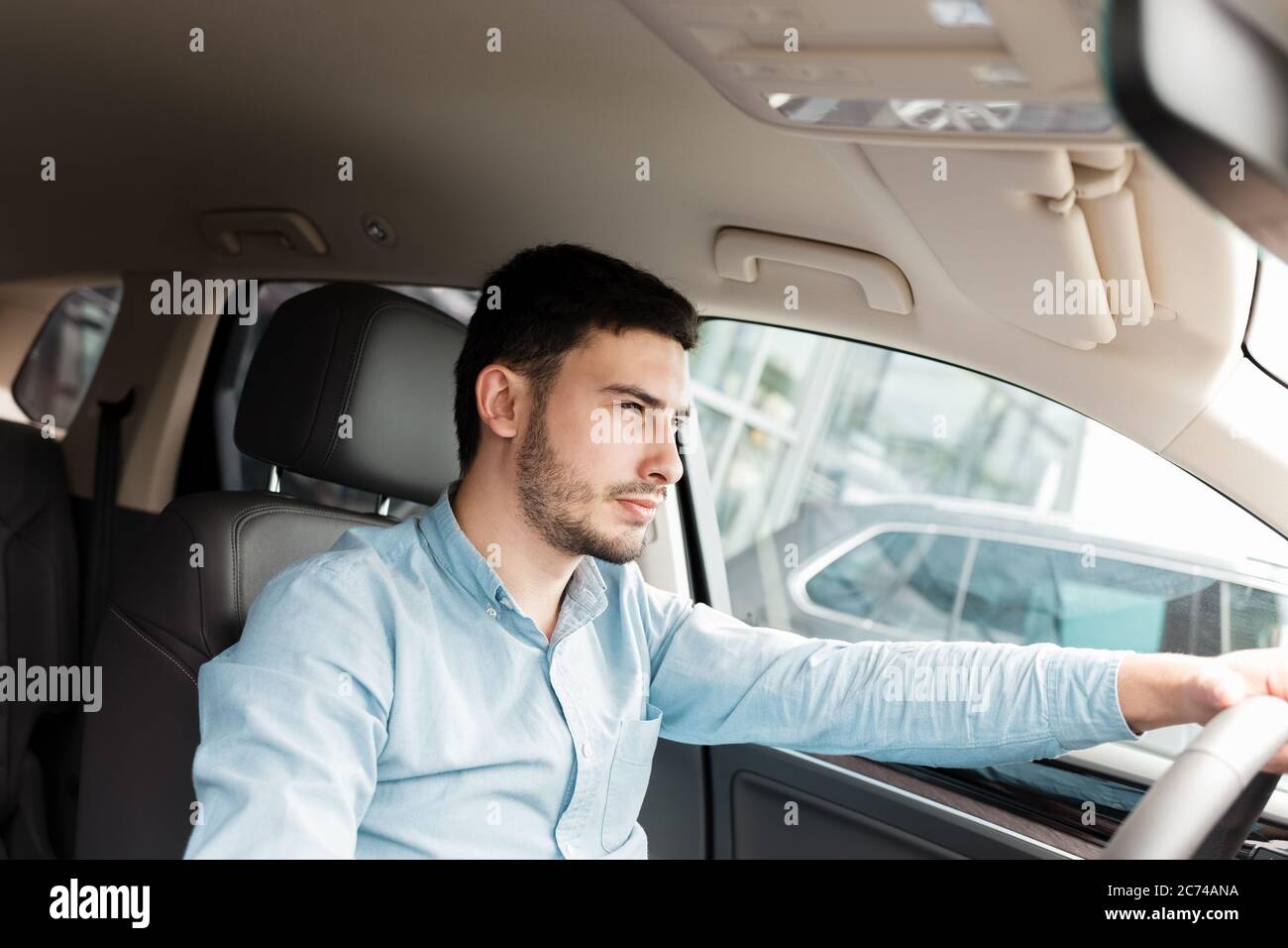 Successful man driving an expensive car Stock Photo - Alamy