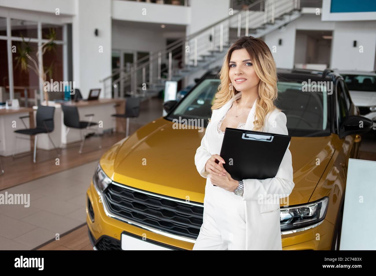 Car sales woman agent at a car dealership Stock Photo - Alamy