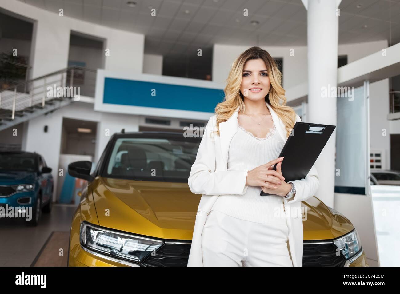 Car sales woman agent at a car dealership Stock Photo - Alamy