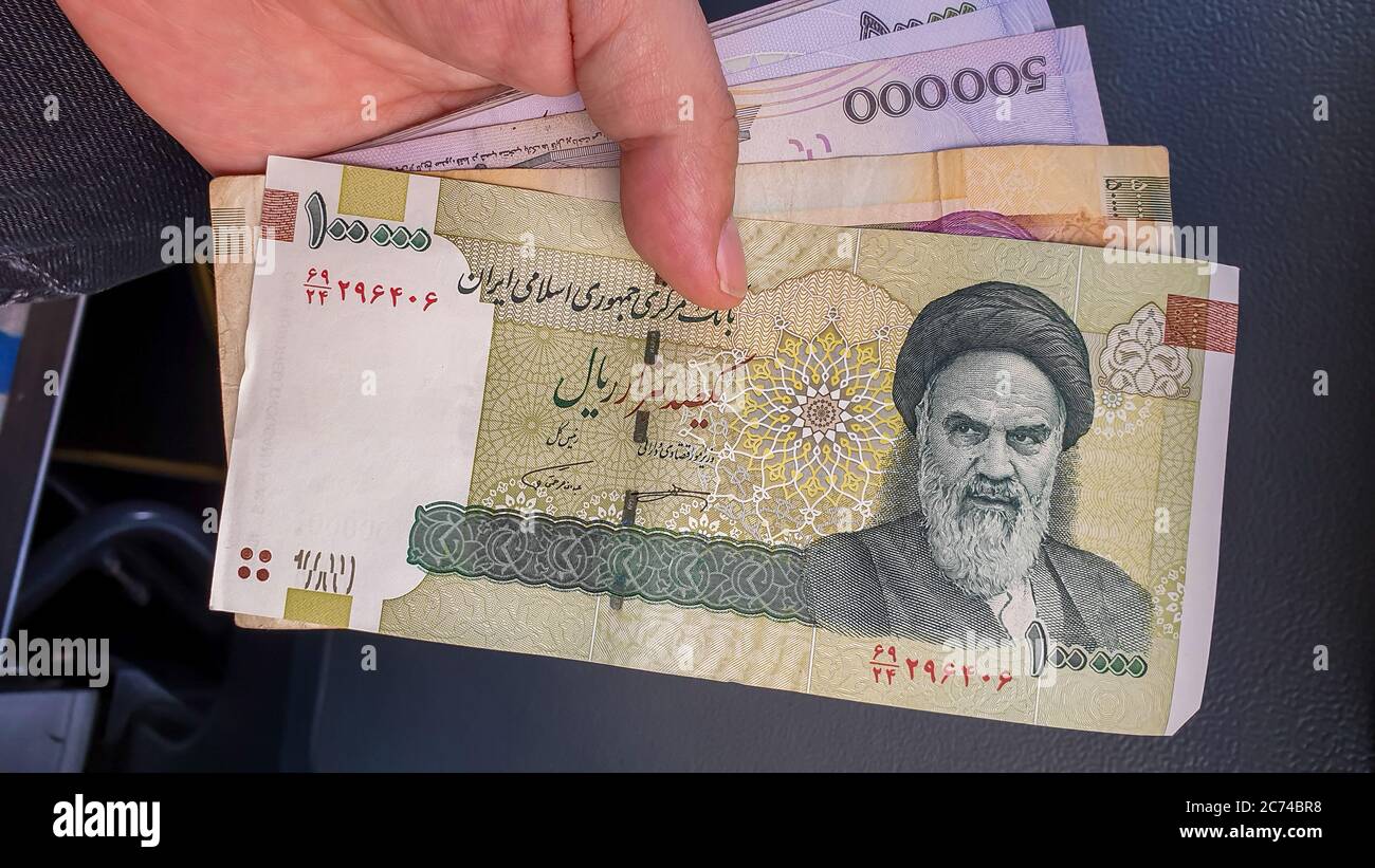 Hand holding Iranian Rial. Rial is the national currency of Iran Stock ...